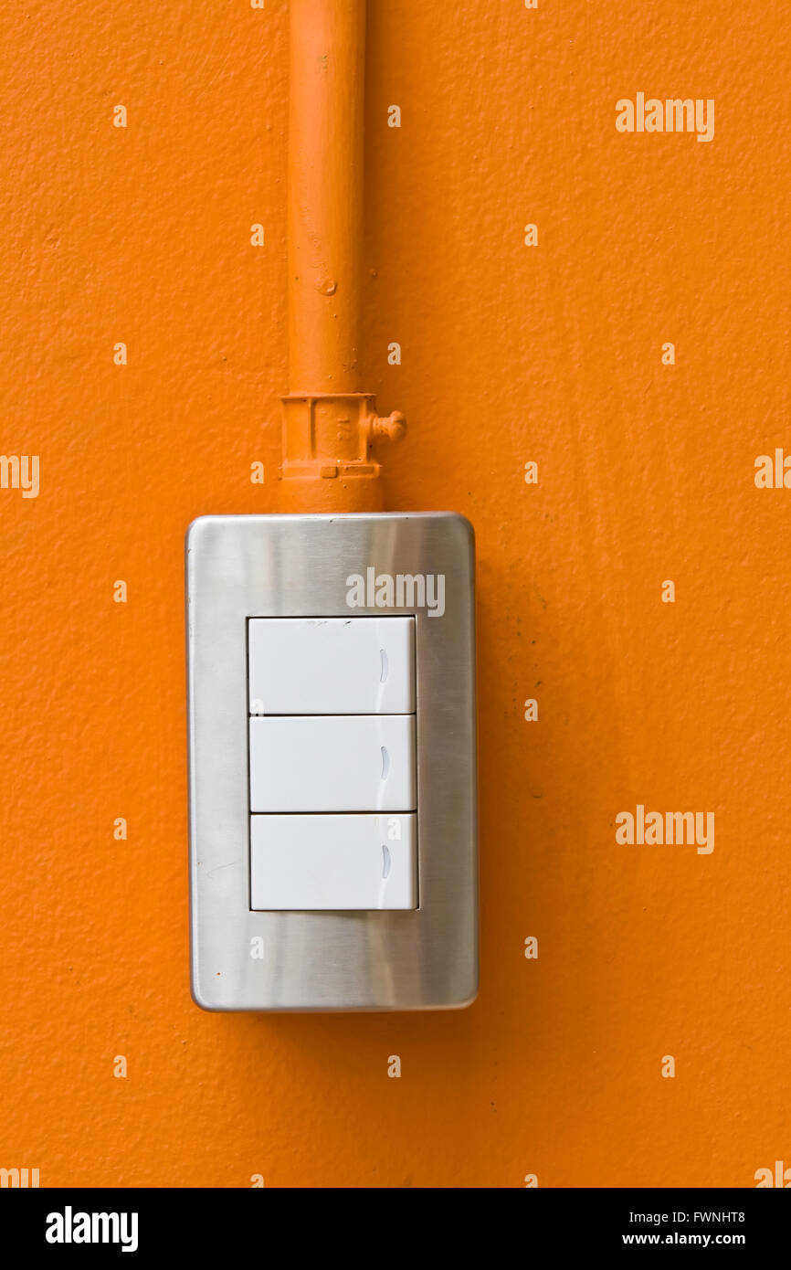 Light Switch on Orange Wall Stock Photo - Alamy
