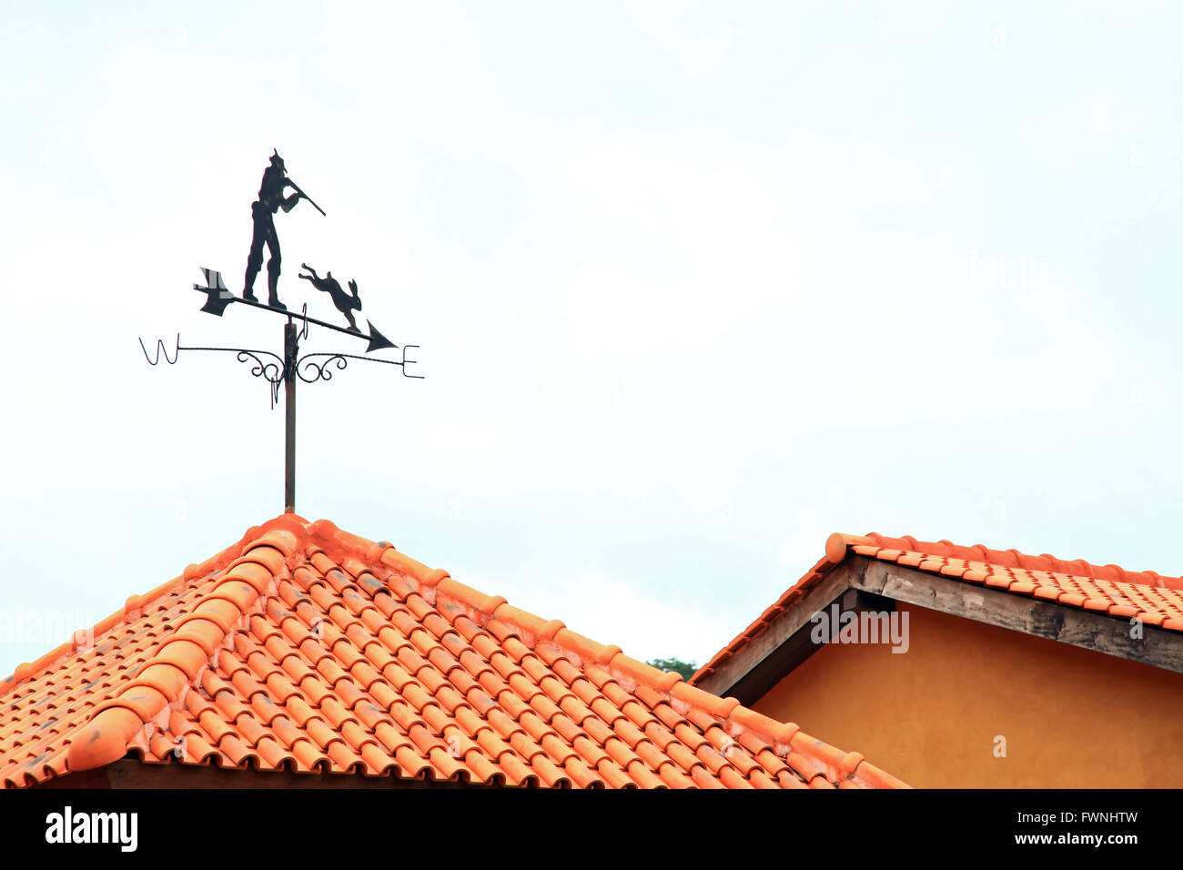 Black Compass wind on red roof Stock Photo - Alamy
