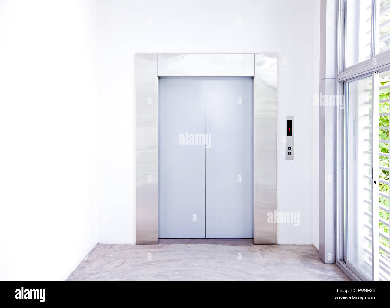 Front view of a modern elevator with closed doors in lobby Stock Photo ...