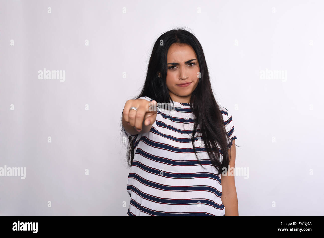 Young beautiful woman pointing to camera. Isolated white background ...
