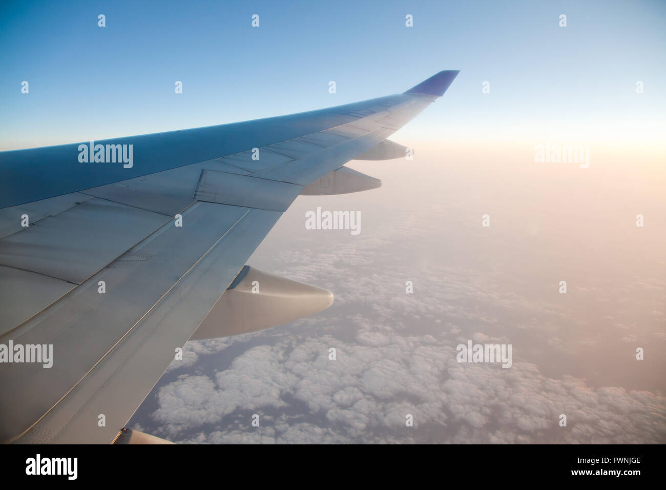 Sunrise with Airplanes wing from its windows with cloudscape Stock ...