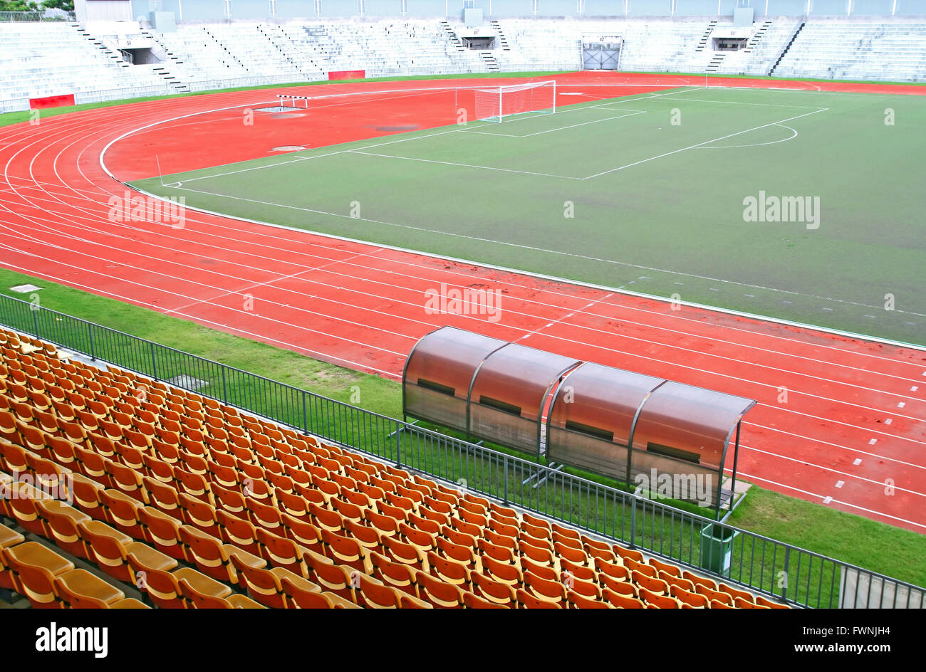 landscape of Coach and reserve benches with yellow seats in football ...