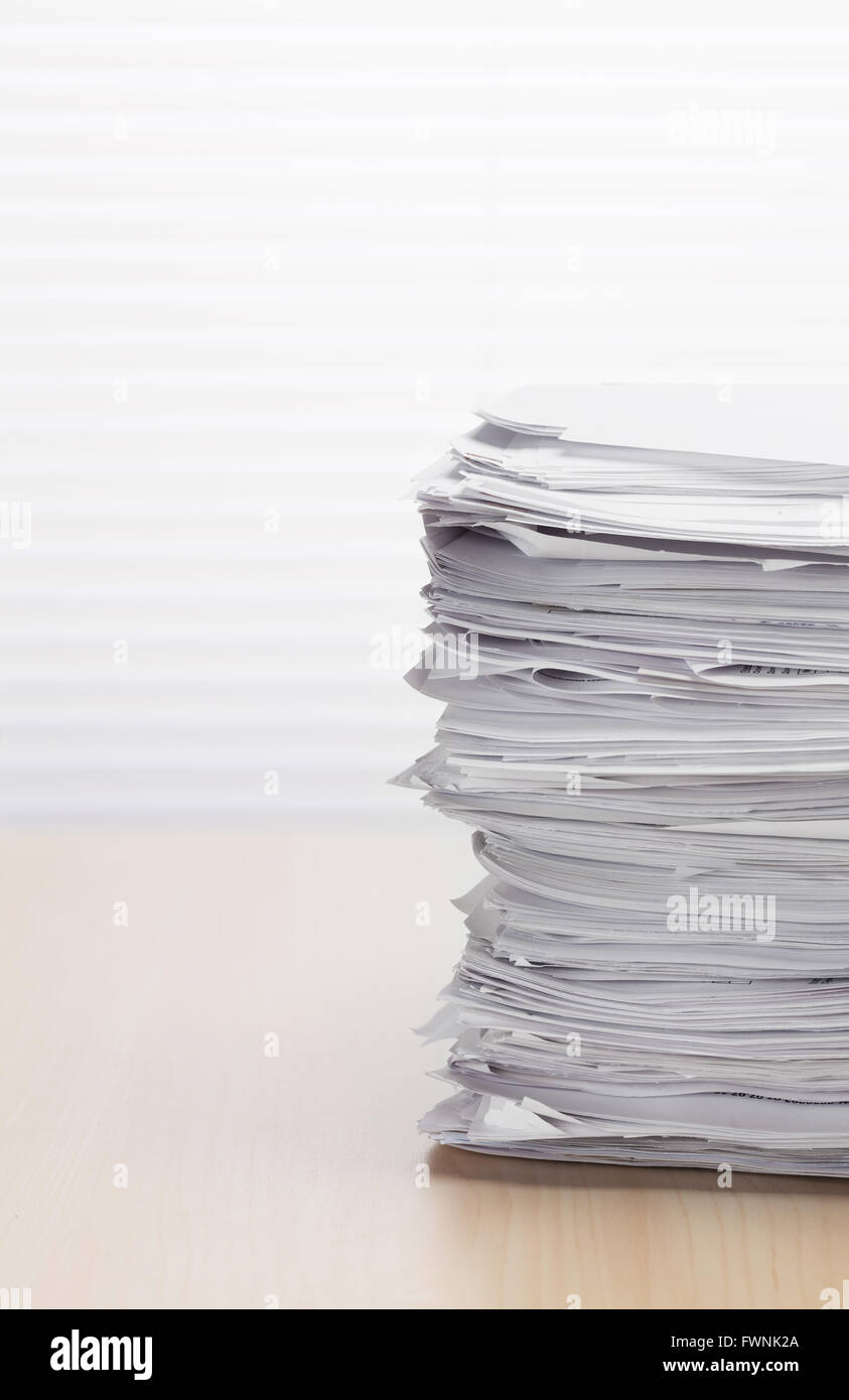 Stack of paper documents on office table Stock Photo - Alamy
