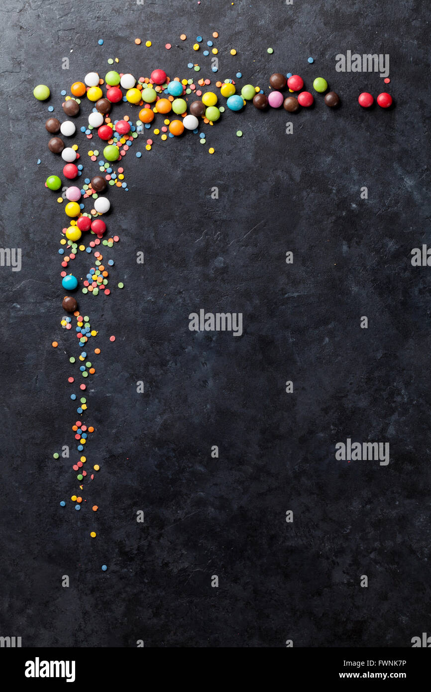 Colorful candies frame on stone background. Top view with copy space ...