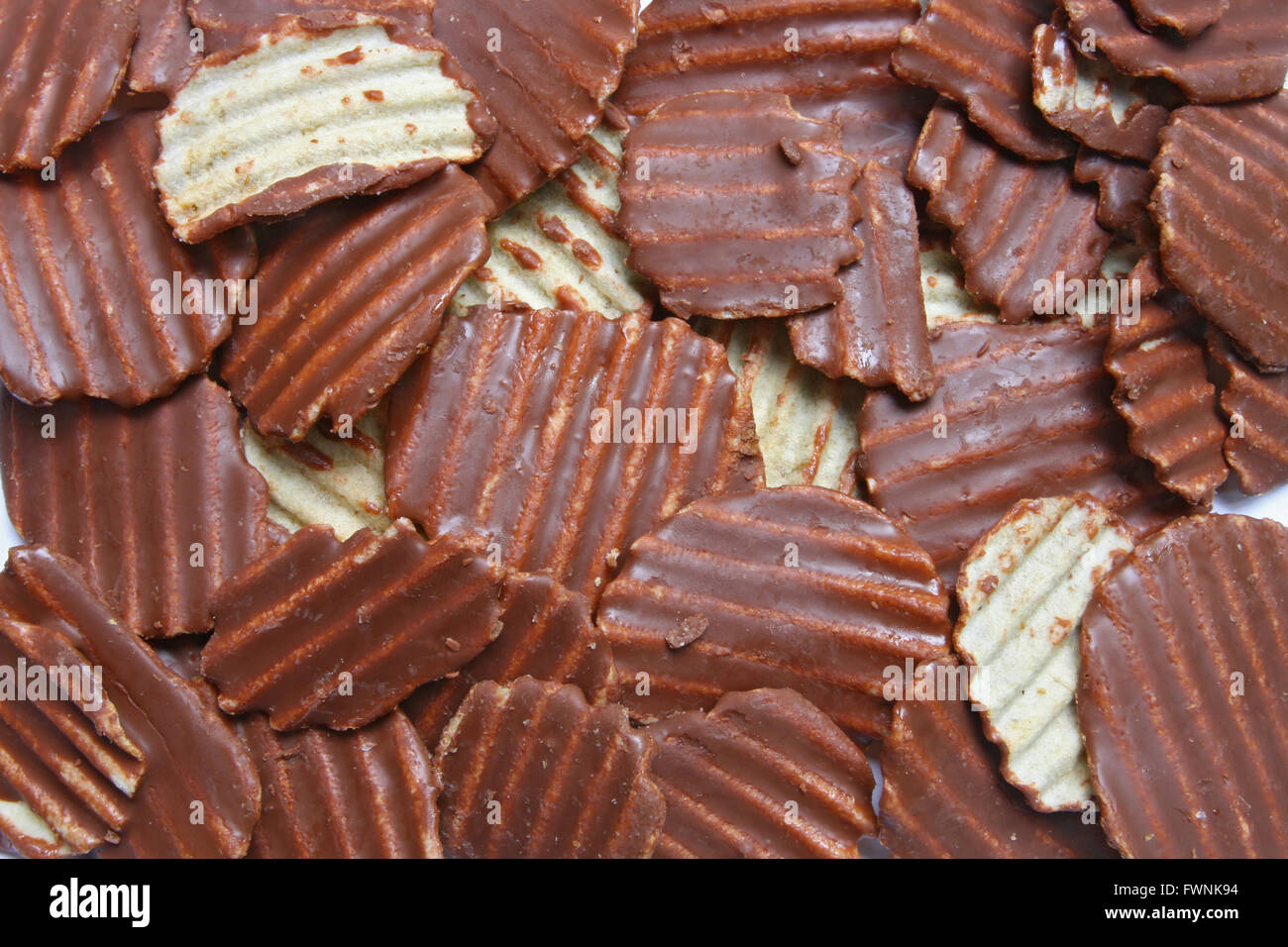 Pattern of Ridged potato chips cover with Chocolate using as background ...