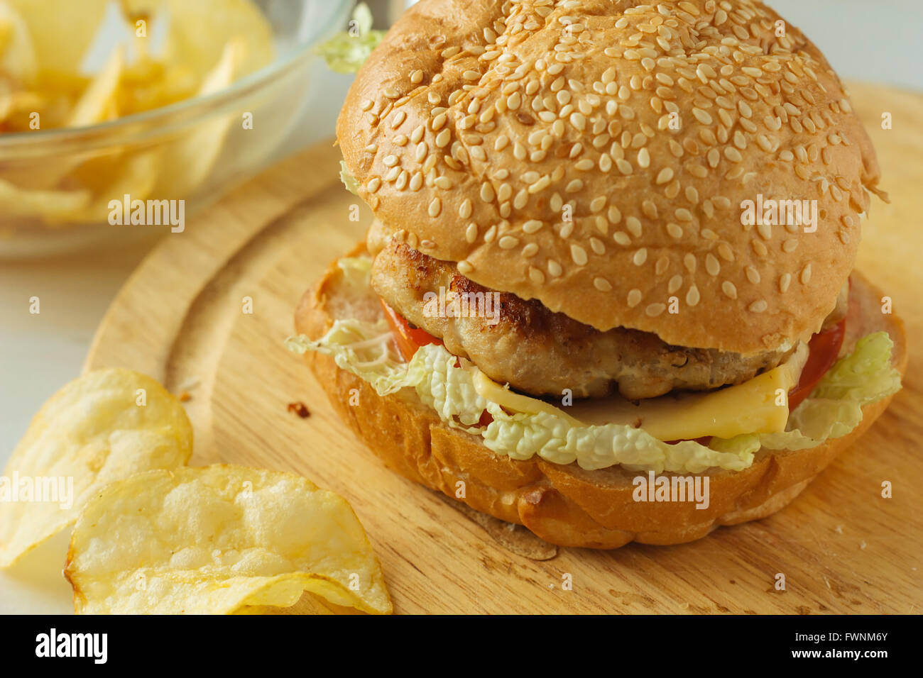 Cheeseburger on wooden plate selective focus horizontal Stock Photo - Alamy