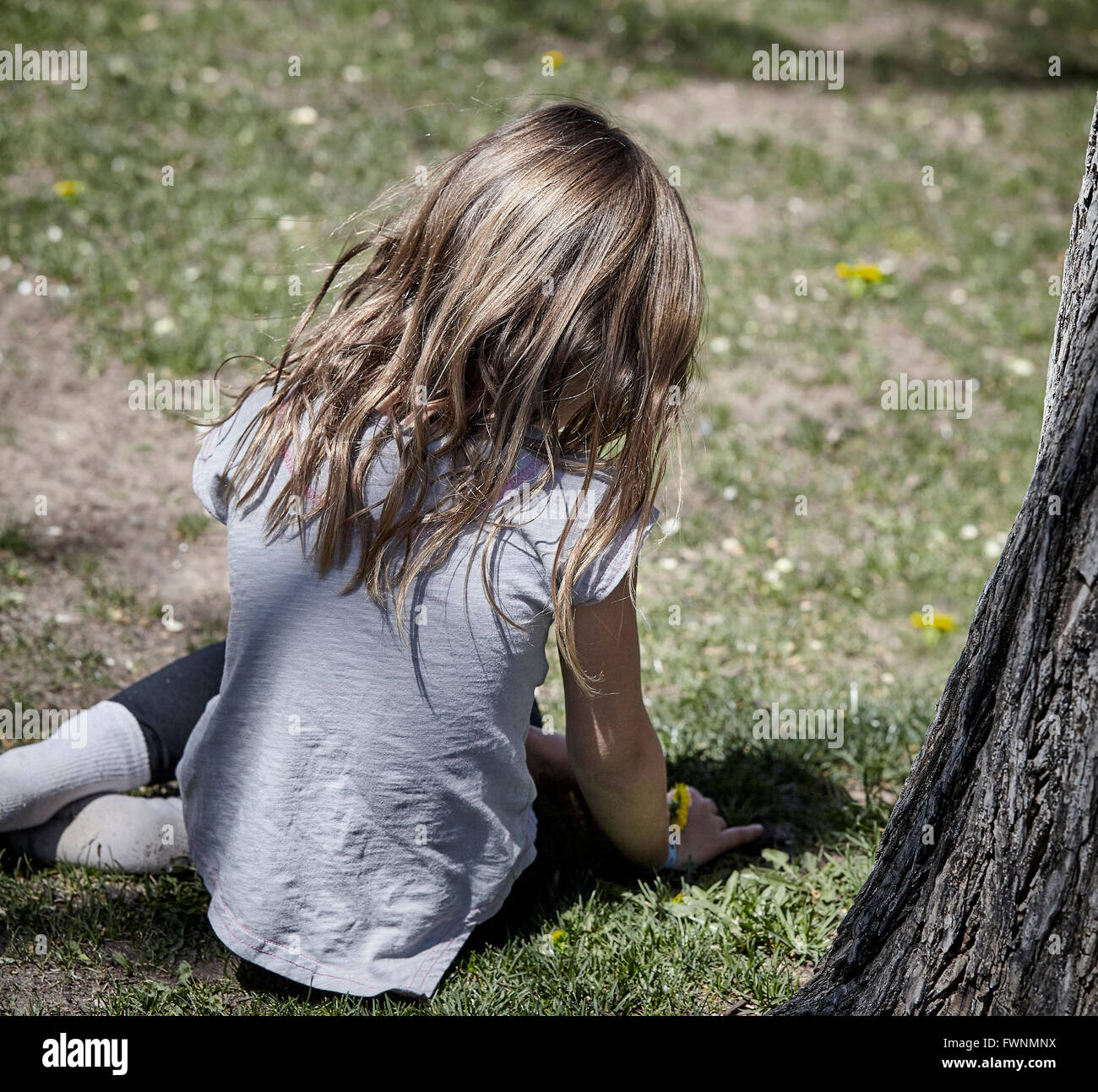 Sad girl sitting grass hi-res stock photography and images - Alamy