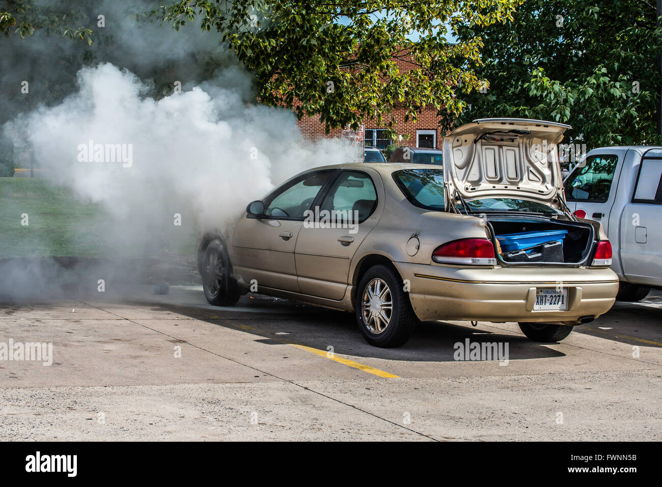 Car fire in parking lot of service station, fast food market Stock ...
