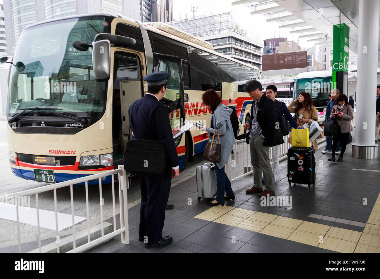 Tokyo, Japan. 6th April, 2016. Passengers line up to board a bus at the ...