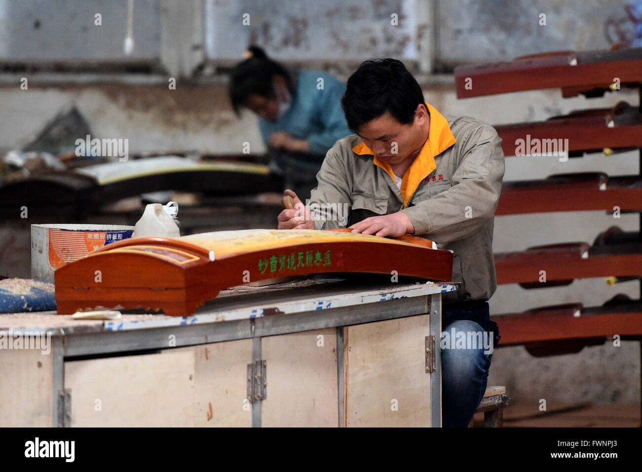 Zhengzhou. 6th Apr, 2016. Workers make Chinese traditional instrument ...