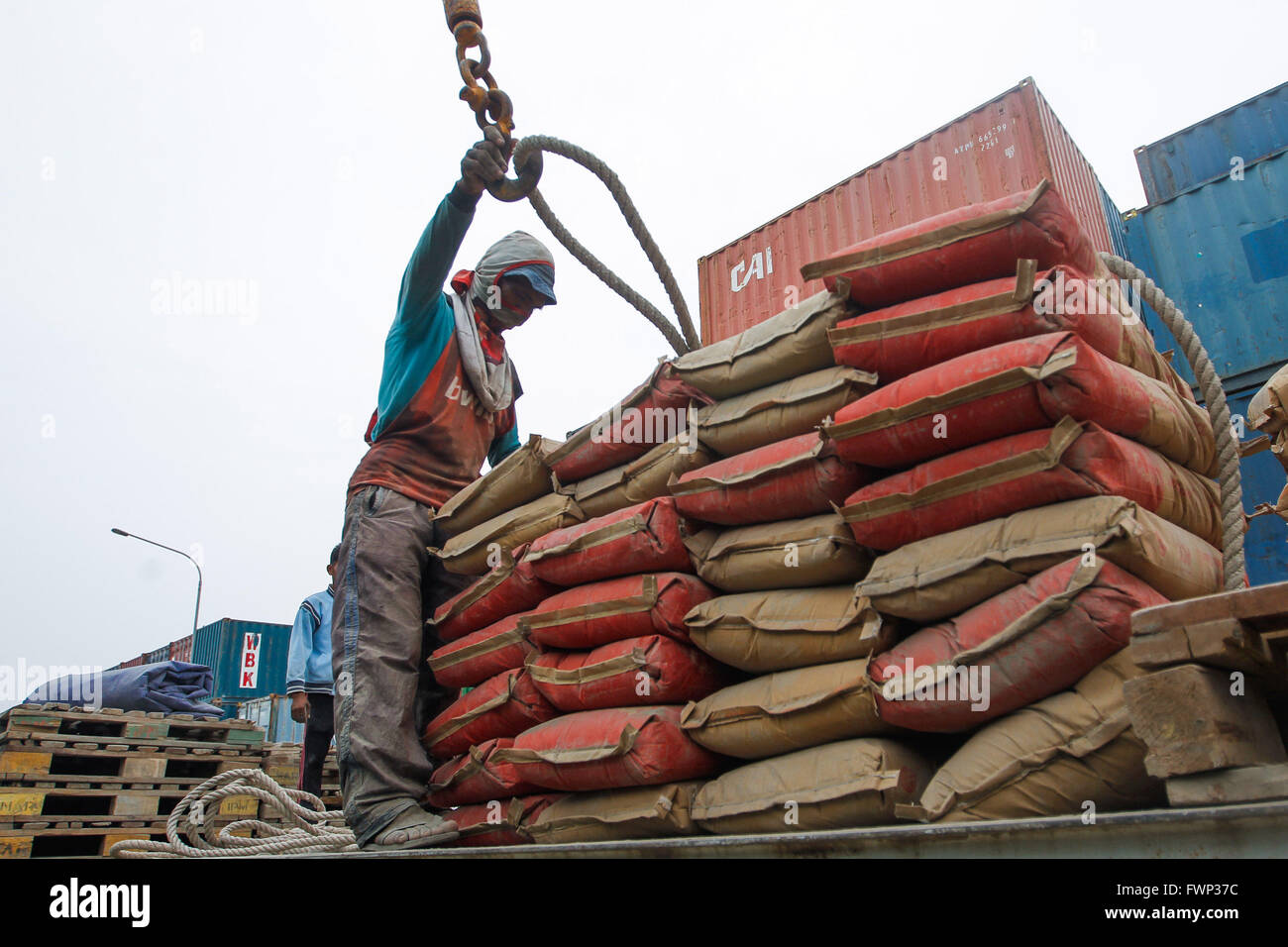 Jakarta, Indonesia. 30th Mar, 2016. A workers load sacks of cement on ...