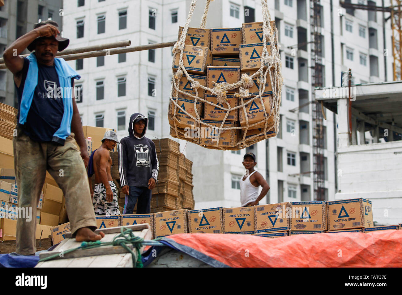 Jakarta, Indonesia. 30th Mar, 2016. Workers load box of wheat flour on ...