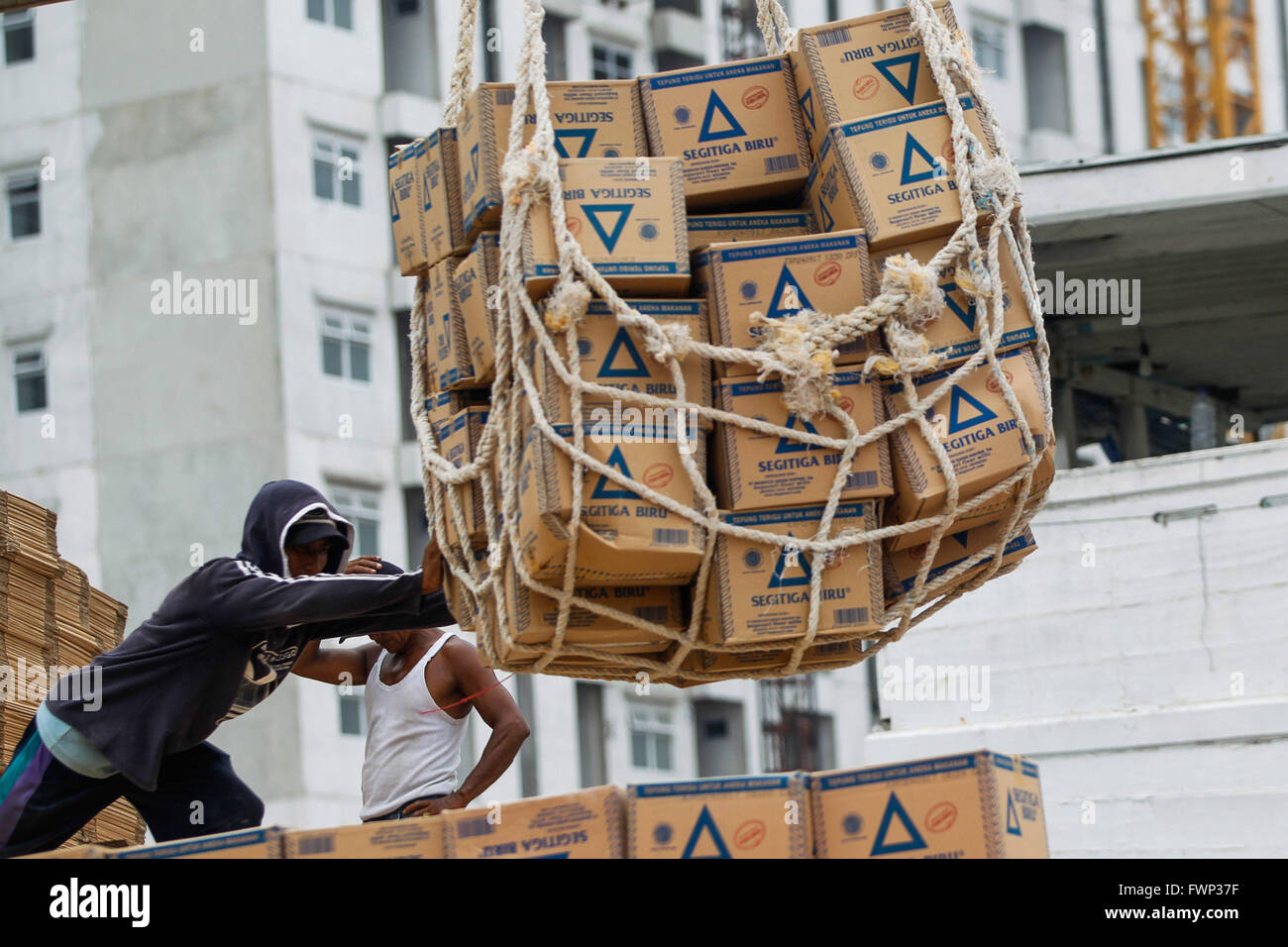 Jakarta, Indonesia. 30th Mar, 2016. Workers load box of wheat flour on ...