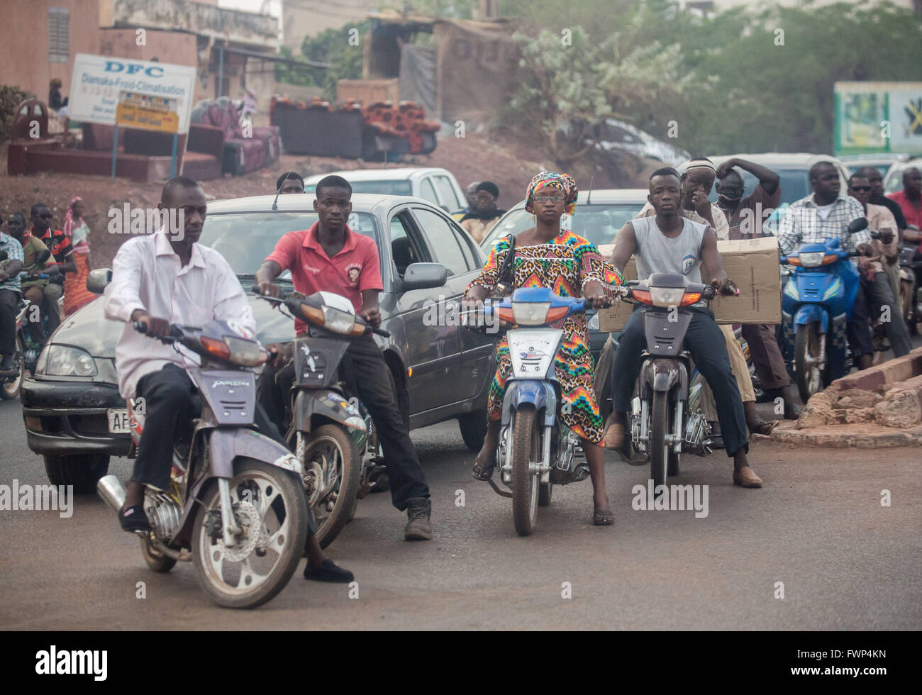 Mopeds and cars wait at an intersection in Bamako, Mali, 05 April 2016 ...