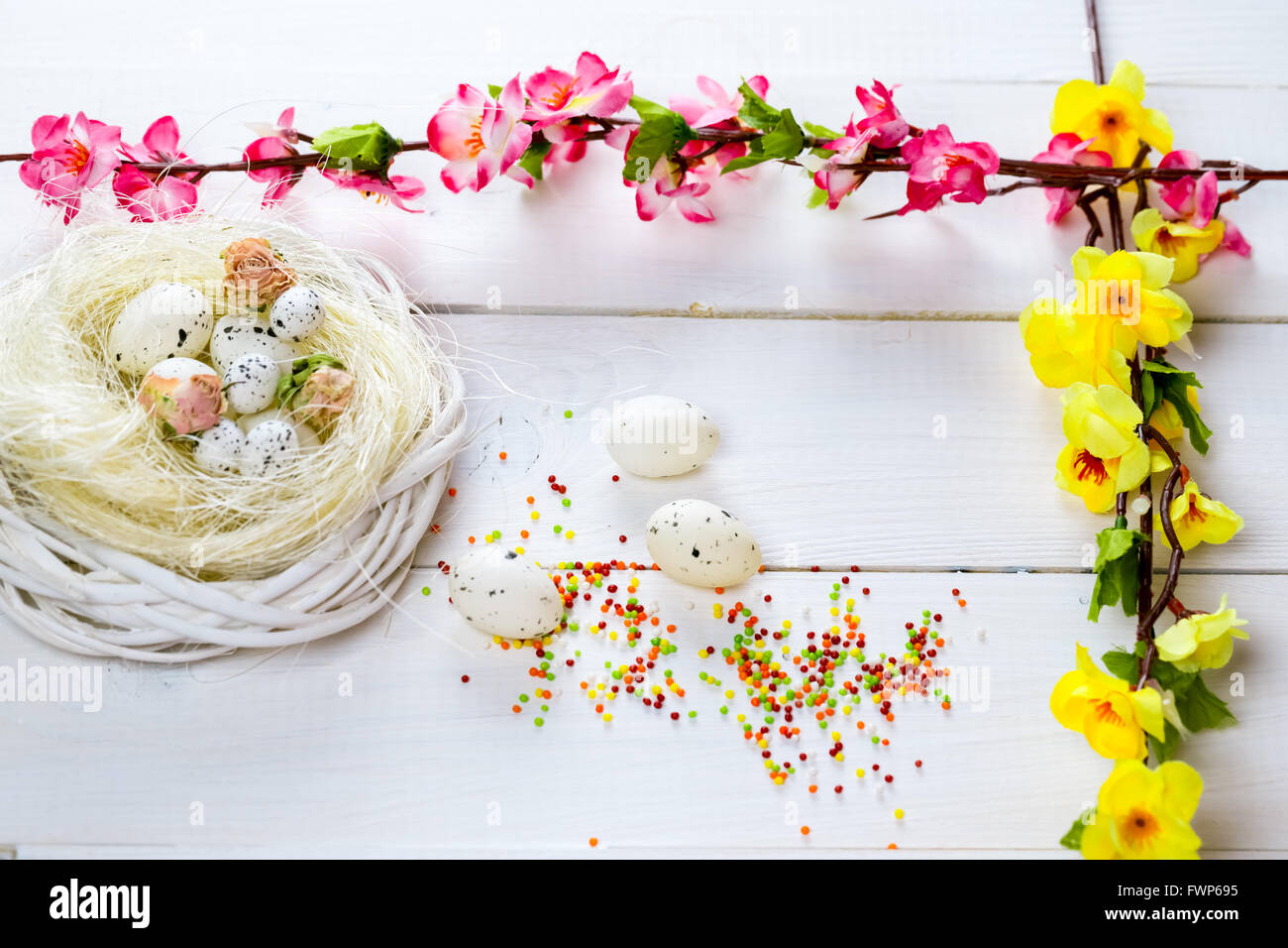 Beautiful Easter background with flowers and nest with eggs on white ...