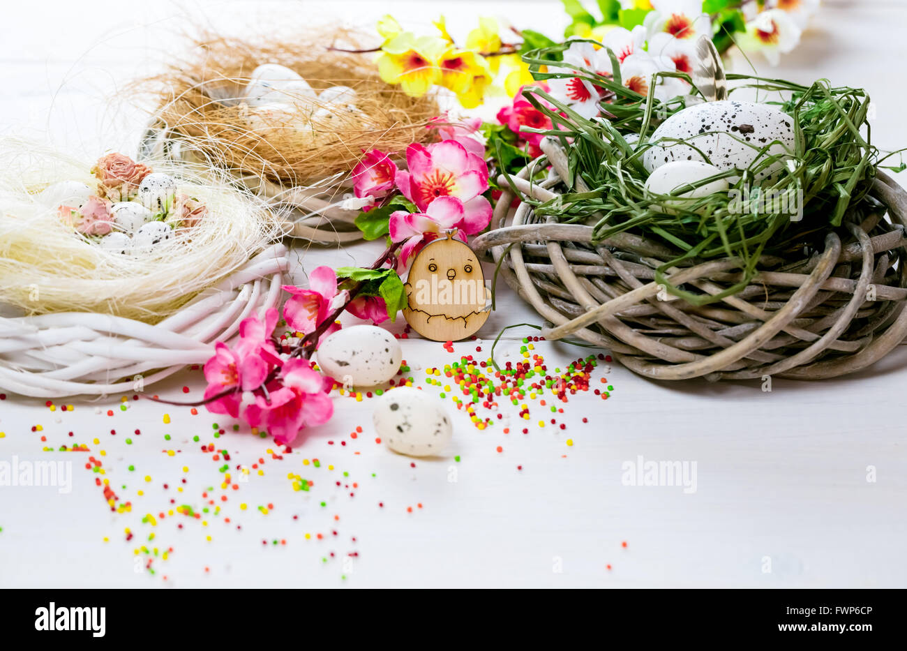 Beautiful Easter background with flowers and nest with eggs on white ...