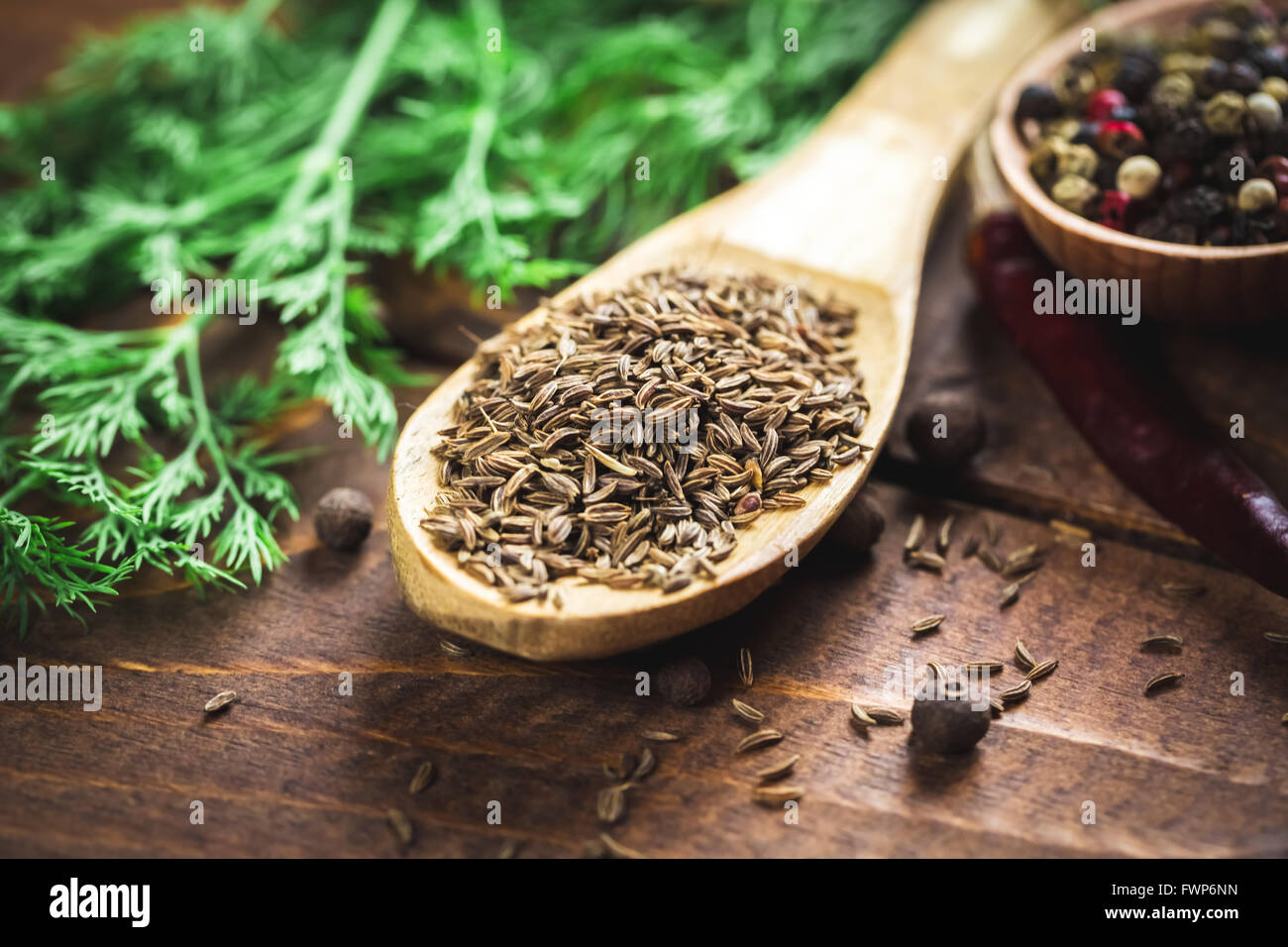 beautiful photo of cumin in wooden spoon on the background of the old ...