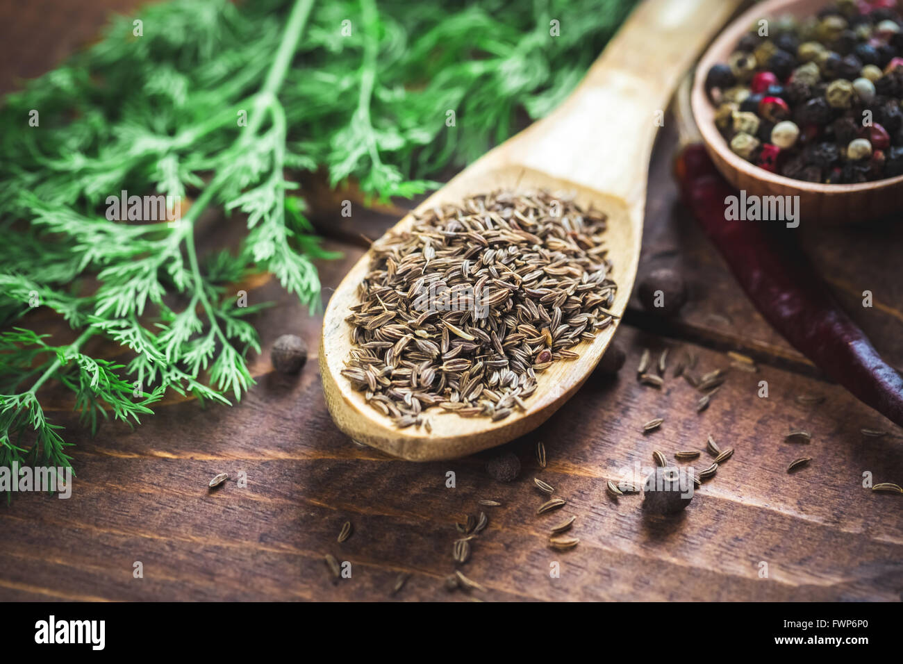 beautiful photo of cumin in wooden spoon on the background of the old ...