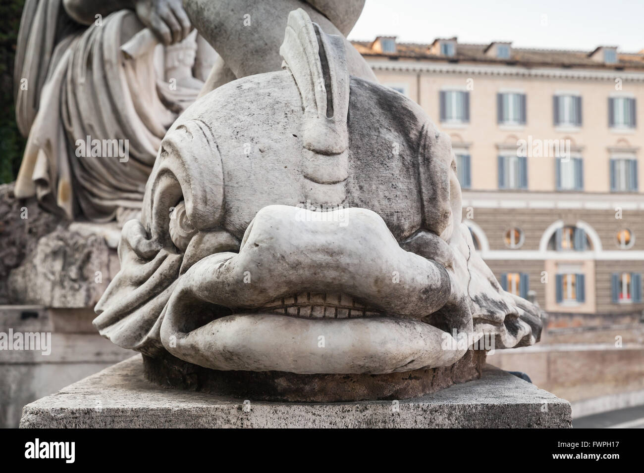 Ancient sculpture with fish on the Piazza del Popolo square, old city ...