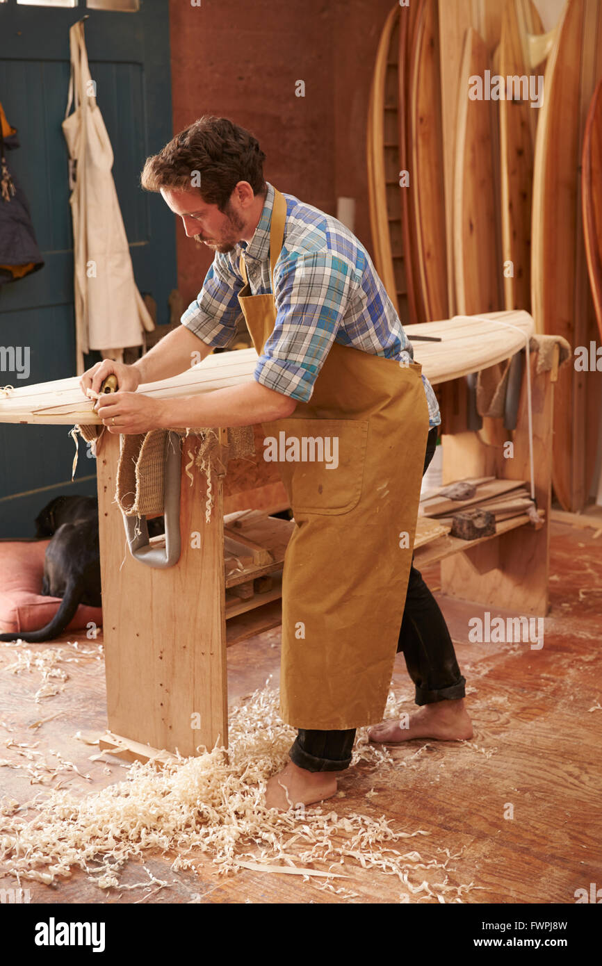Carpenter Planing Bespoke Wooden Surfboard In Workshop Stock Photo - Alamy