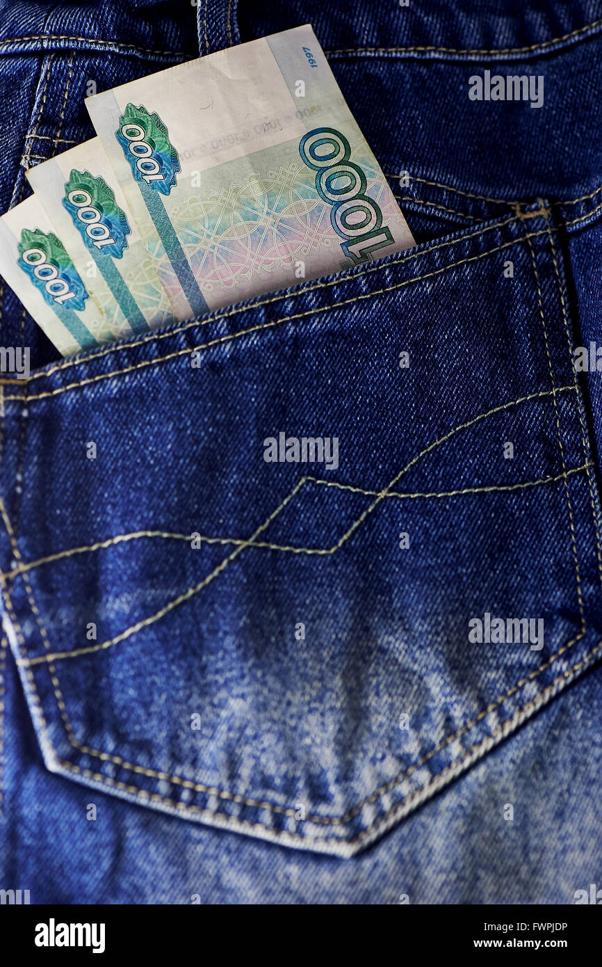 Russian rubles stick out of a hip-pocket of blue jeans Stock Photo - Alamy