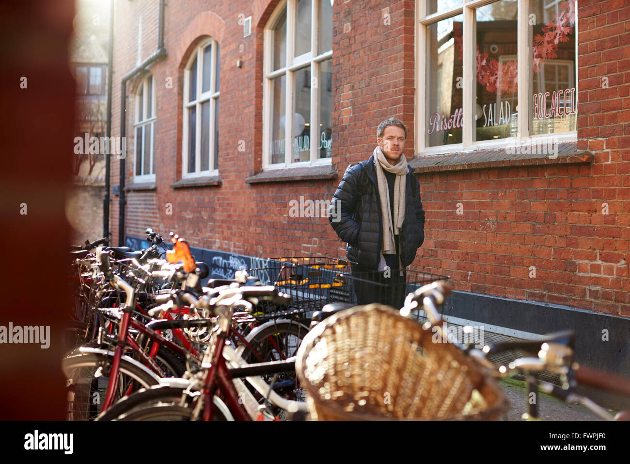 Young Man Walking Through City Street Stock Photo - Alamy