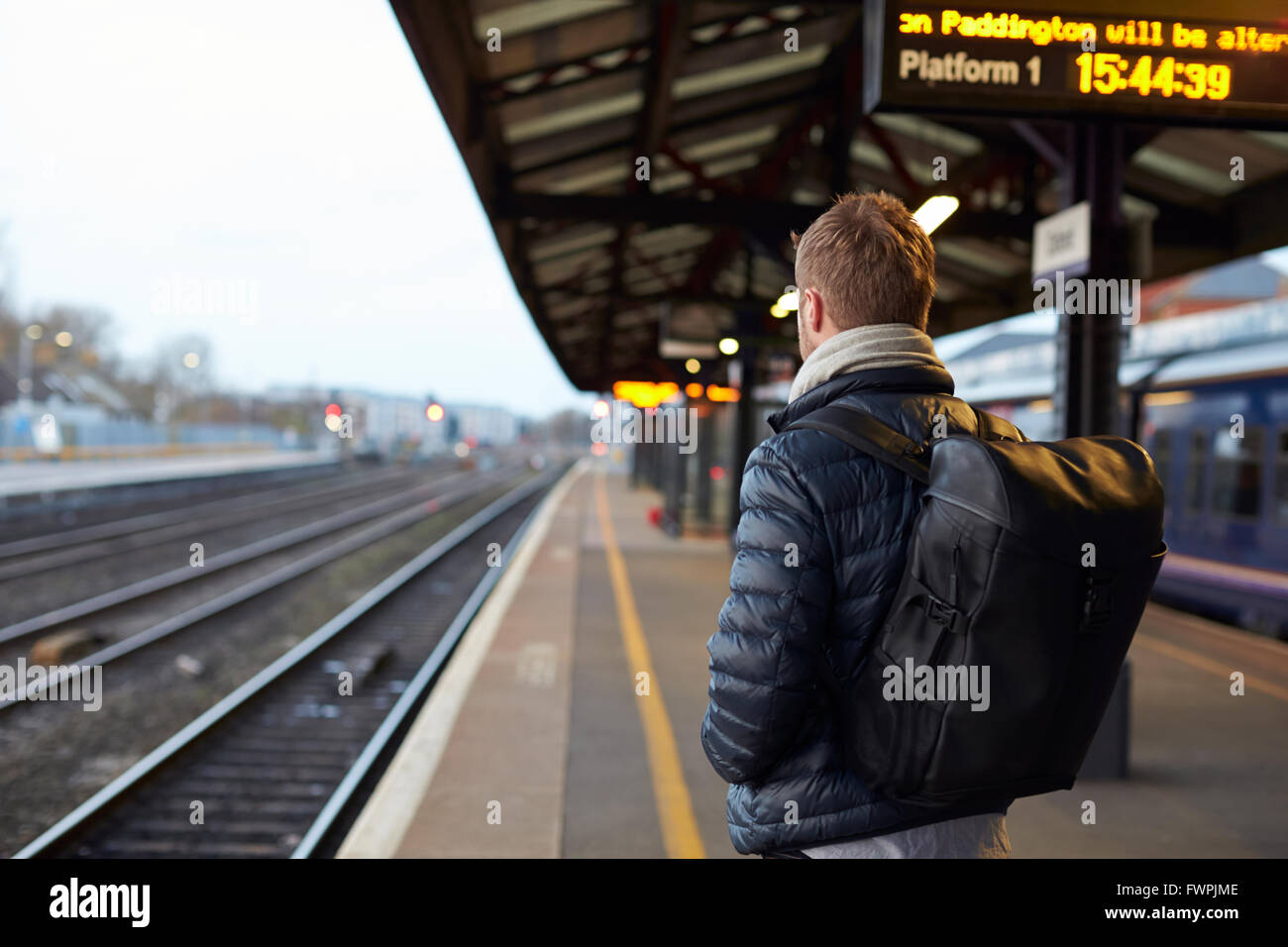 Man Standing On Railway Platform Waiting For Train To Arrive Stock ...