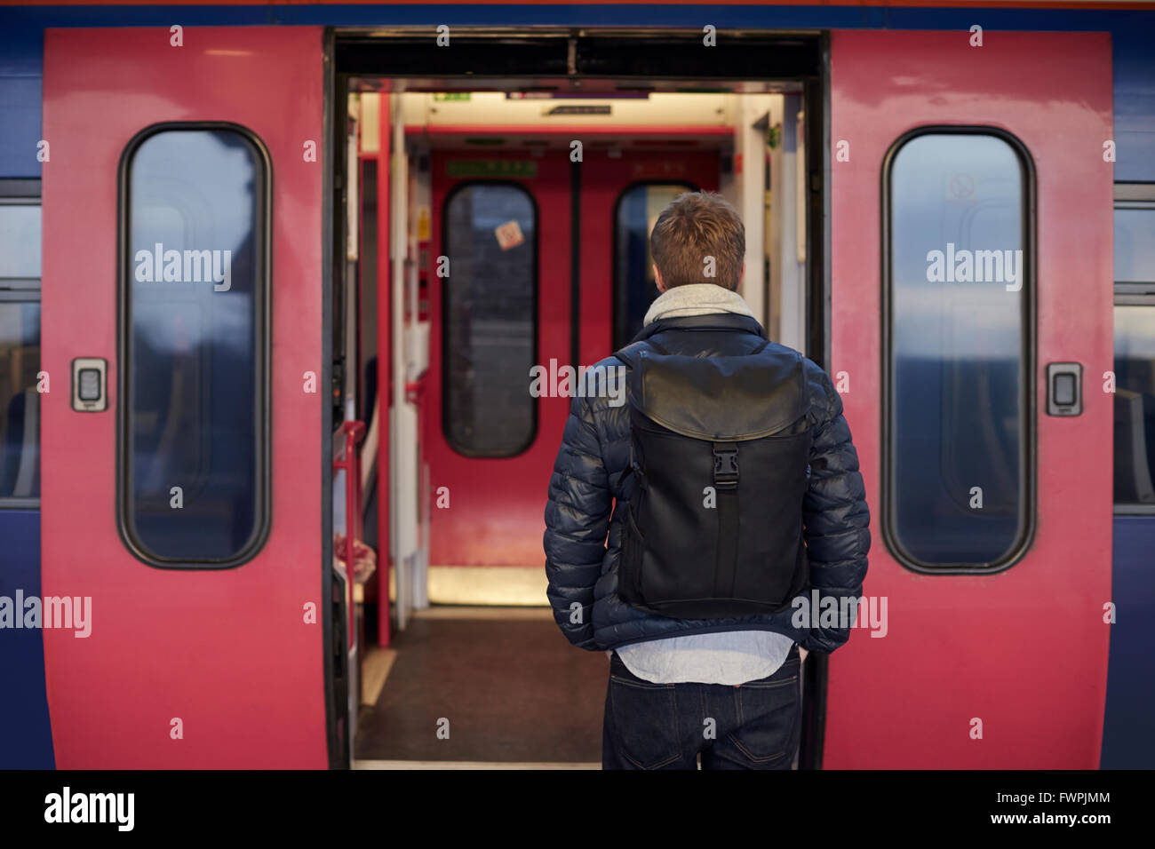 Man Standing On Railway Platform Waiting To Board Train Stock Photo - Alamy