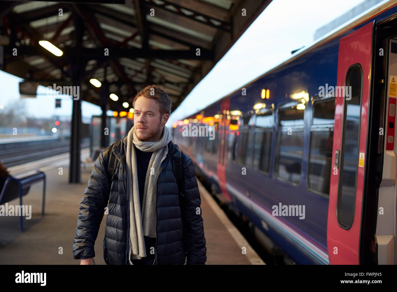 Man Standing On Railway Platform Waiting To Board Train Stock Photo - Alamy