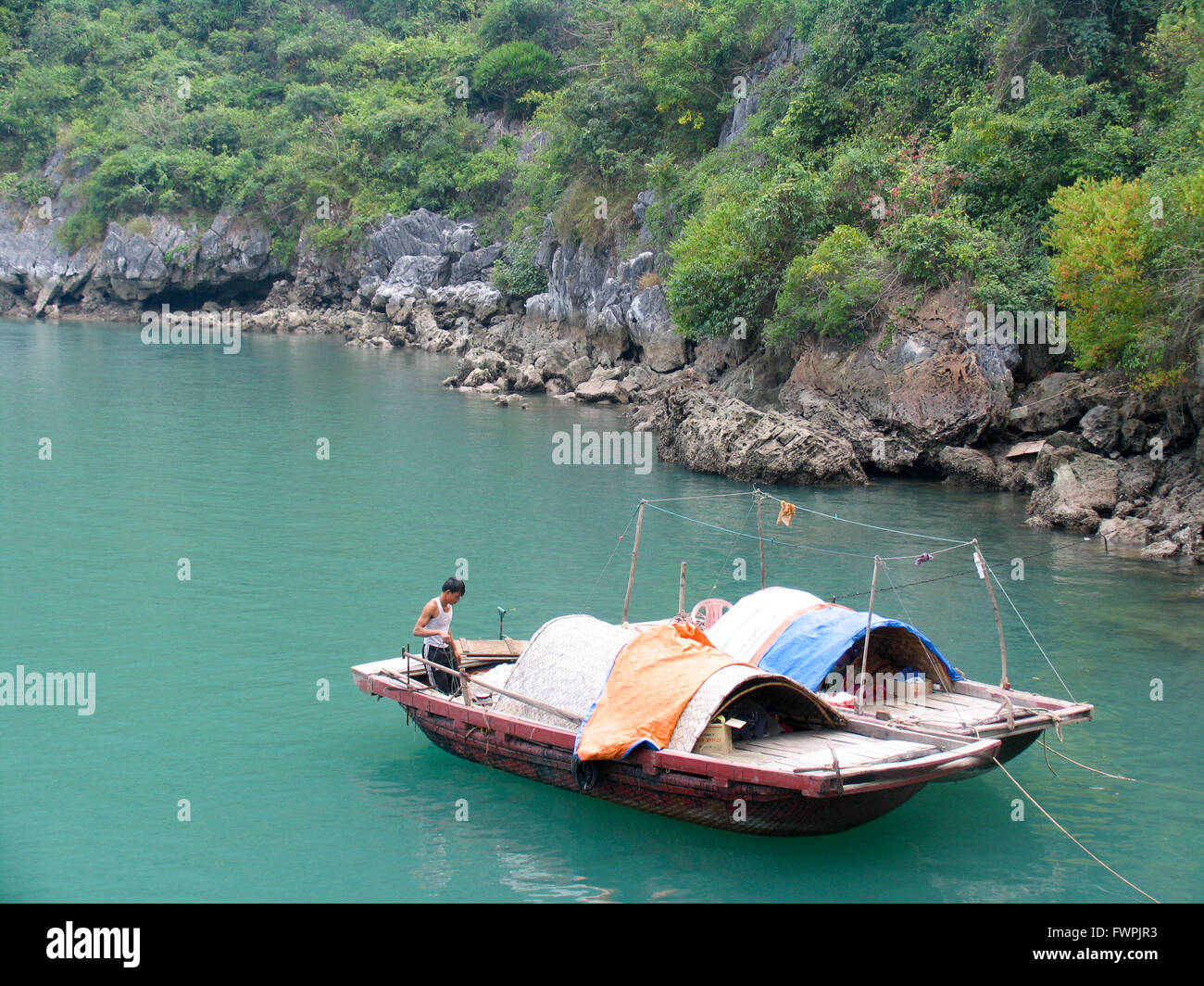 A boatman on two wooden boats Stock Photo - Alamy