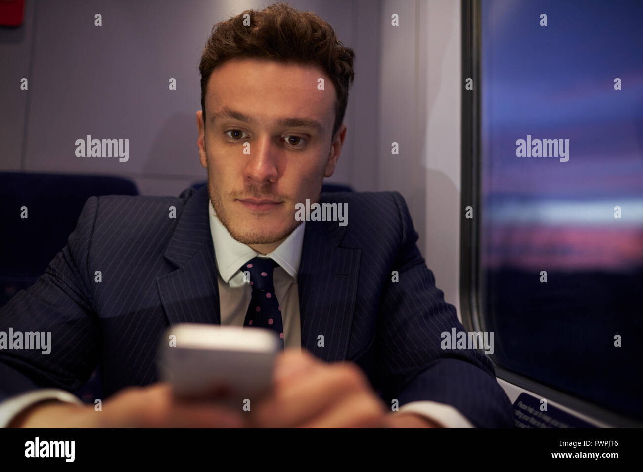 Businessman texting railroad station hi-res stock photography and ...