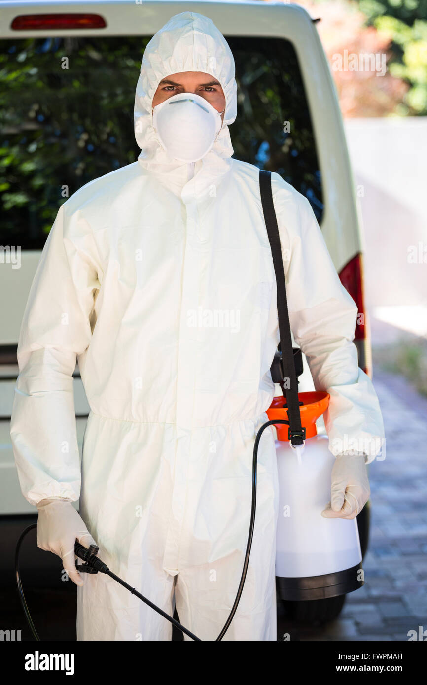 Pest control man standing behind a van Stock Photo - Alamy