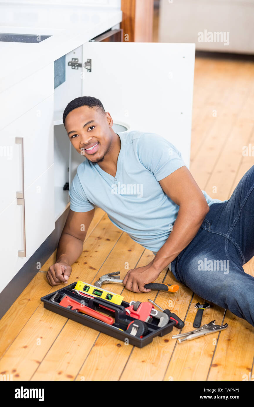 Man repairing a kitchen sink Stock Photo - Alamy