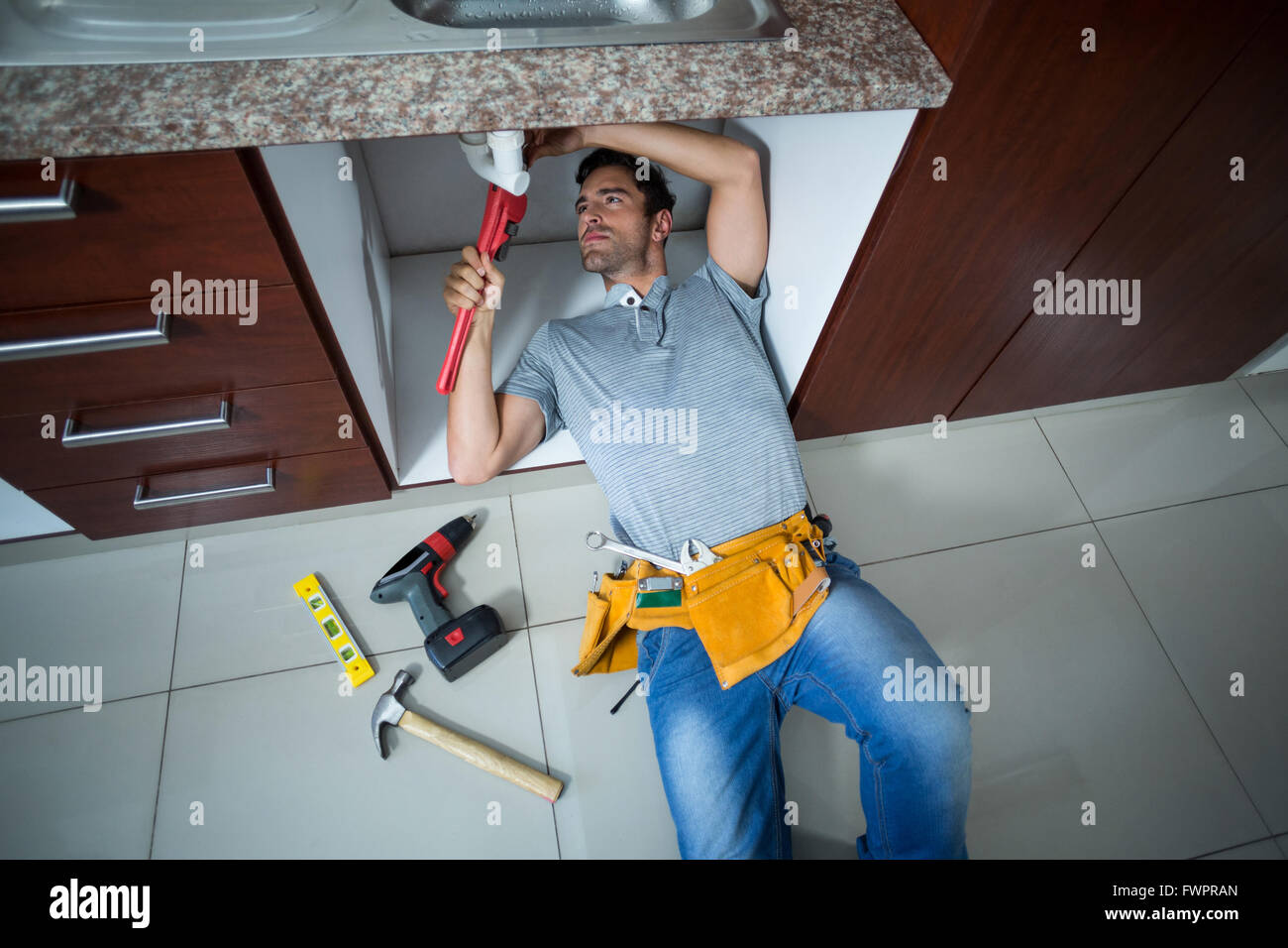 High angle view of man fixing sink pipe Stock Photo - Alamy