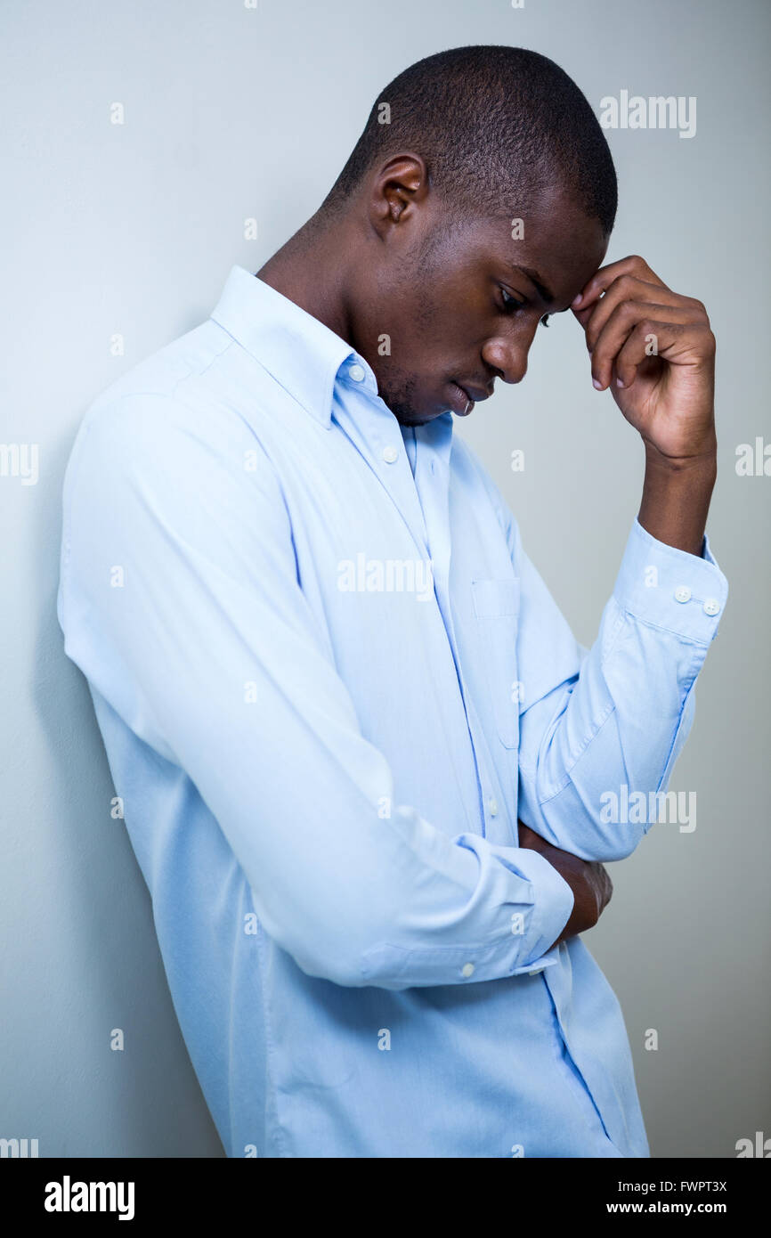 Tensed man leaning on wall Stock Photo - Alamy