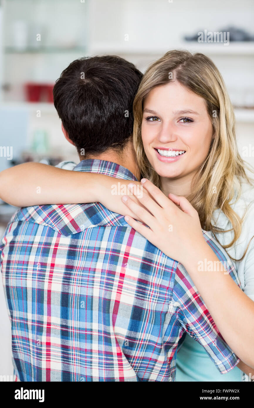 Happy young couple cuddling Stock Photo - Alamy