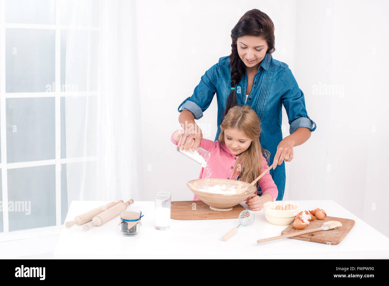 Happy mother and daughter baking Stock Photo - Alamy