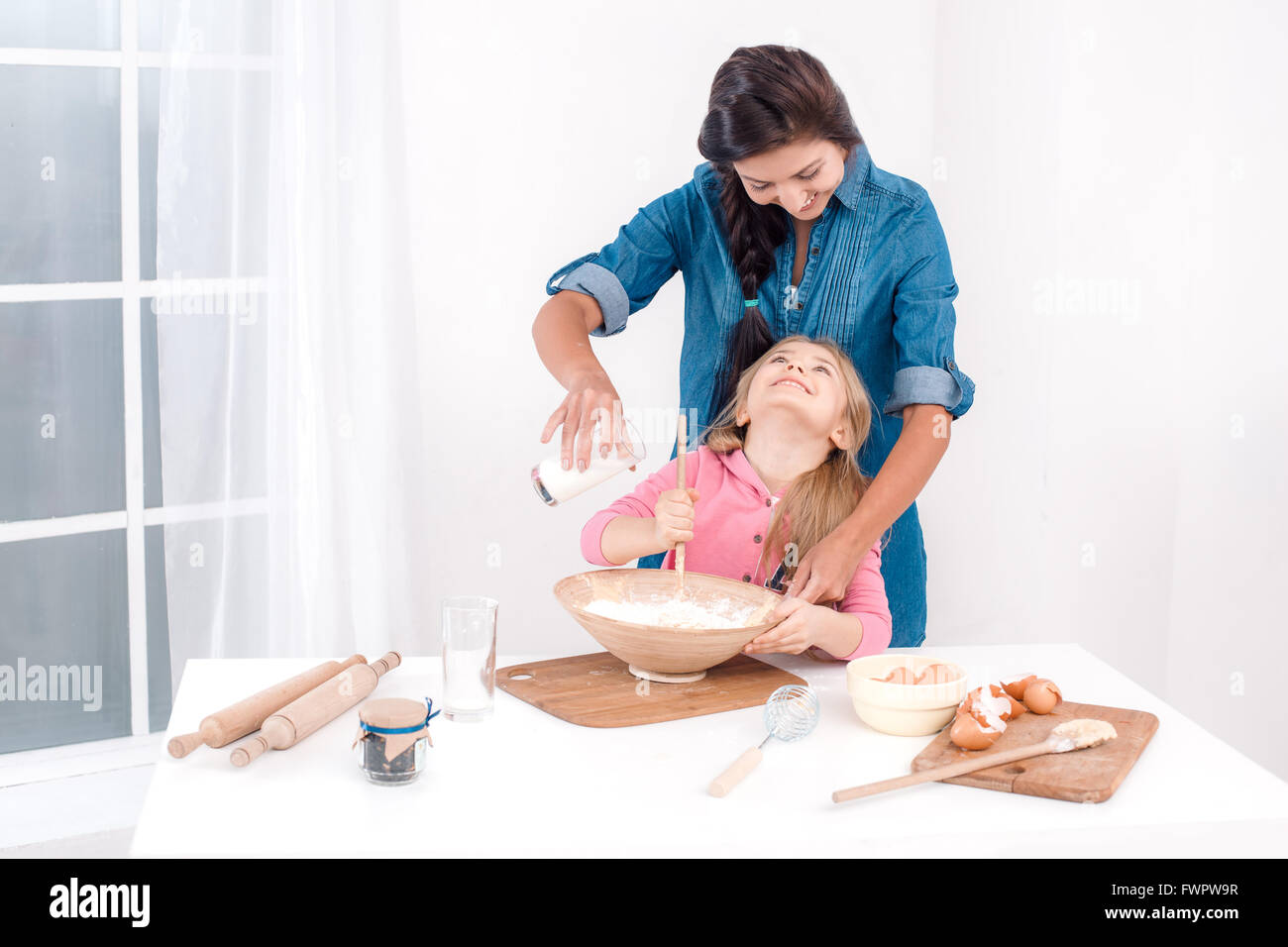 Happy mother and daughter baking Stock Photo - Alamy