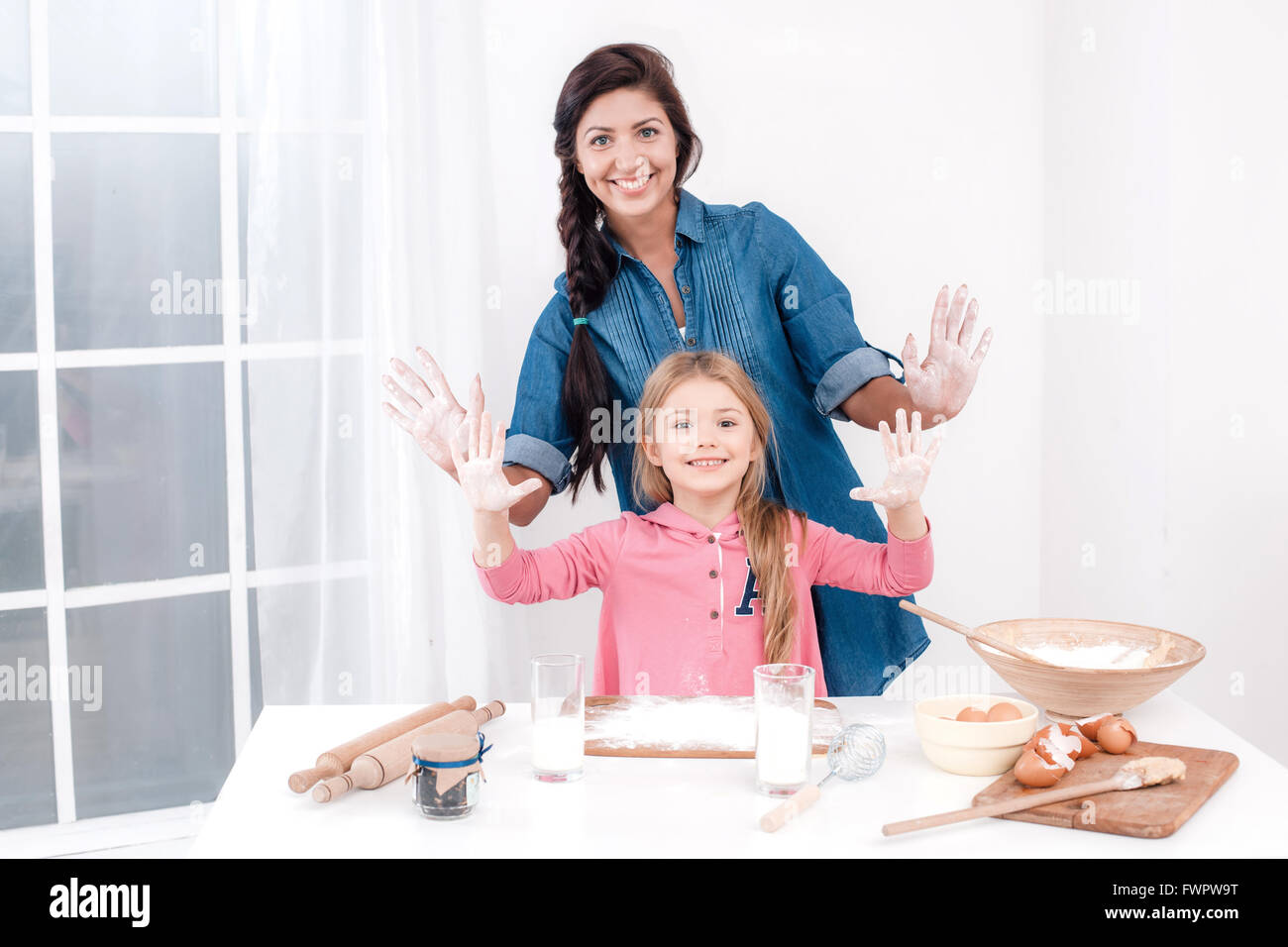Happy mother and daughter baking Stock Photo - Alamy