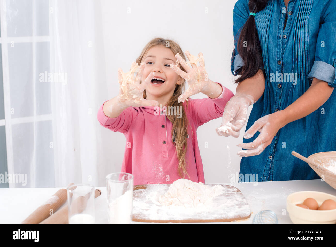 Happy mother and daughter baking Stock Photo - Alamy