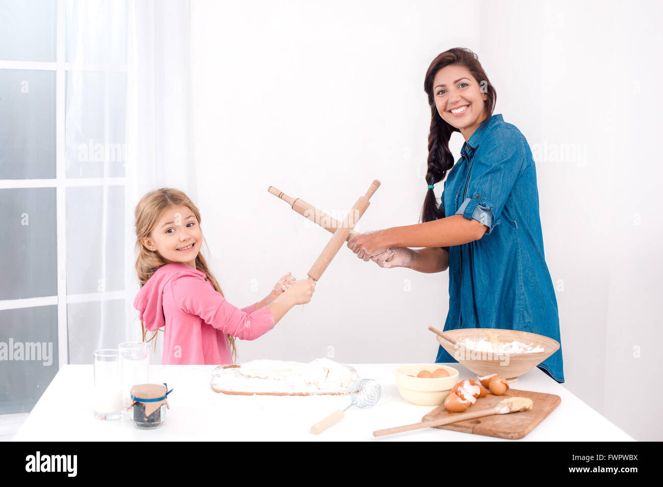 Happy mother and daughter baking Stock Photo - Alamy