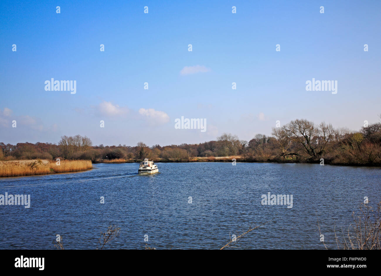 A view of a launch on the River Yare approaching Surlingham Ferry ...