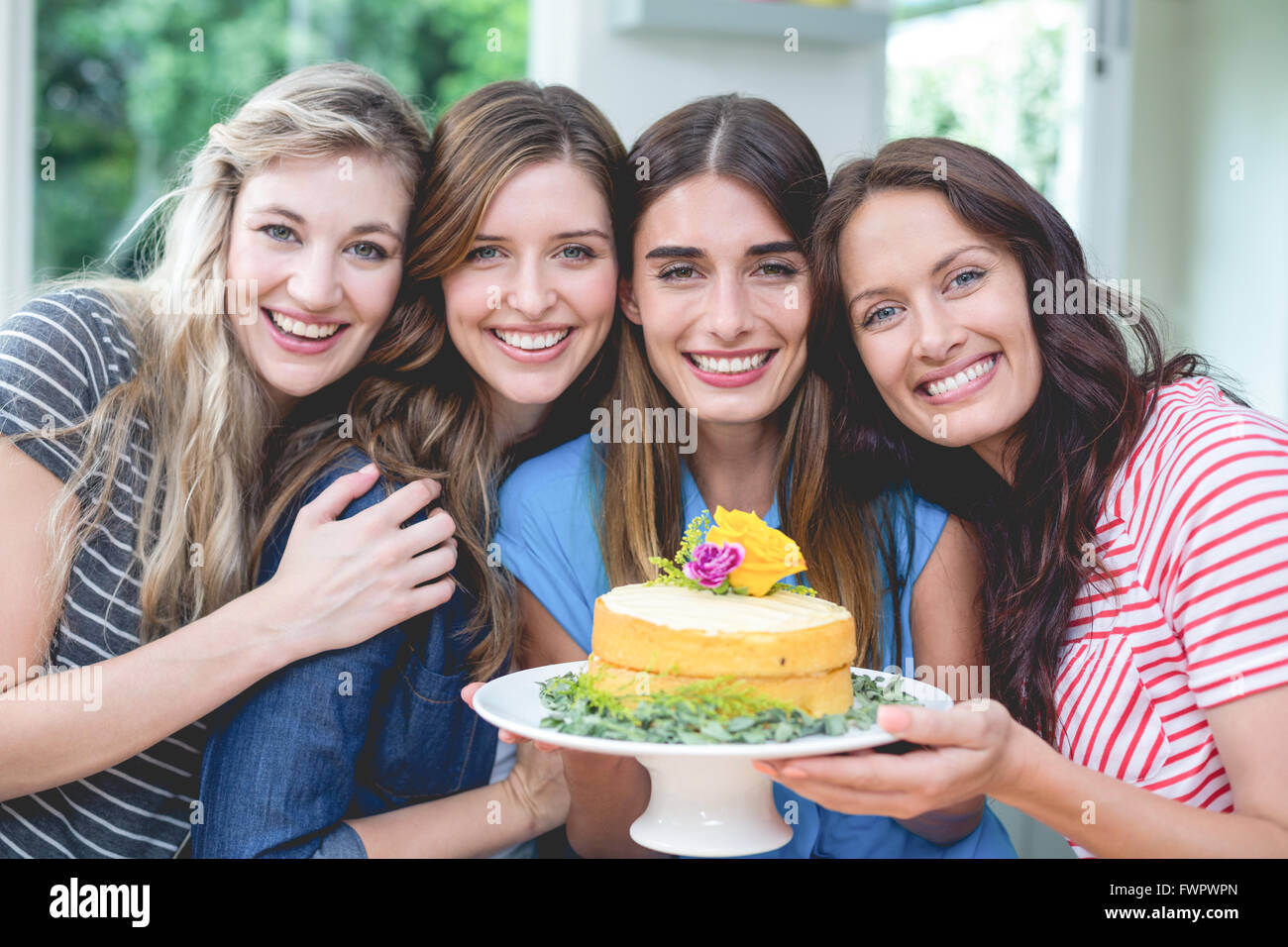 Portrait of beautiful women holding a birthday cake Stock Photo - Alamy