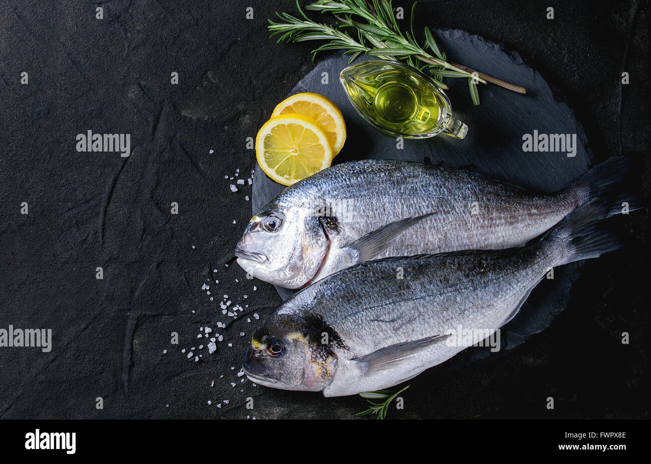 Raw bream fish with herbs Stock Photo - Alamy