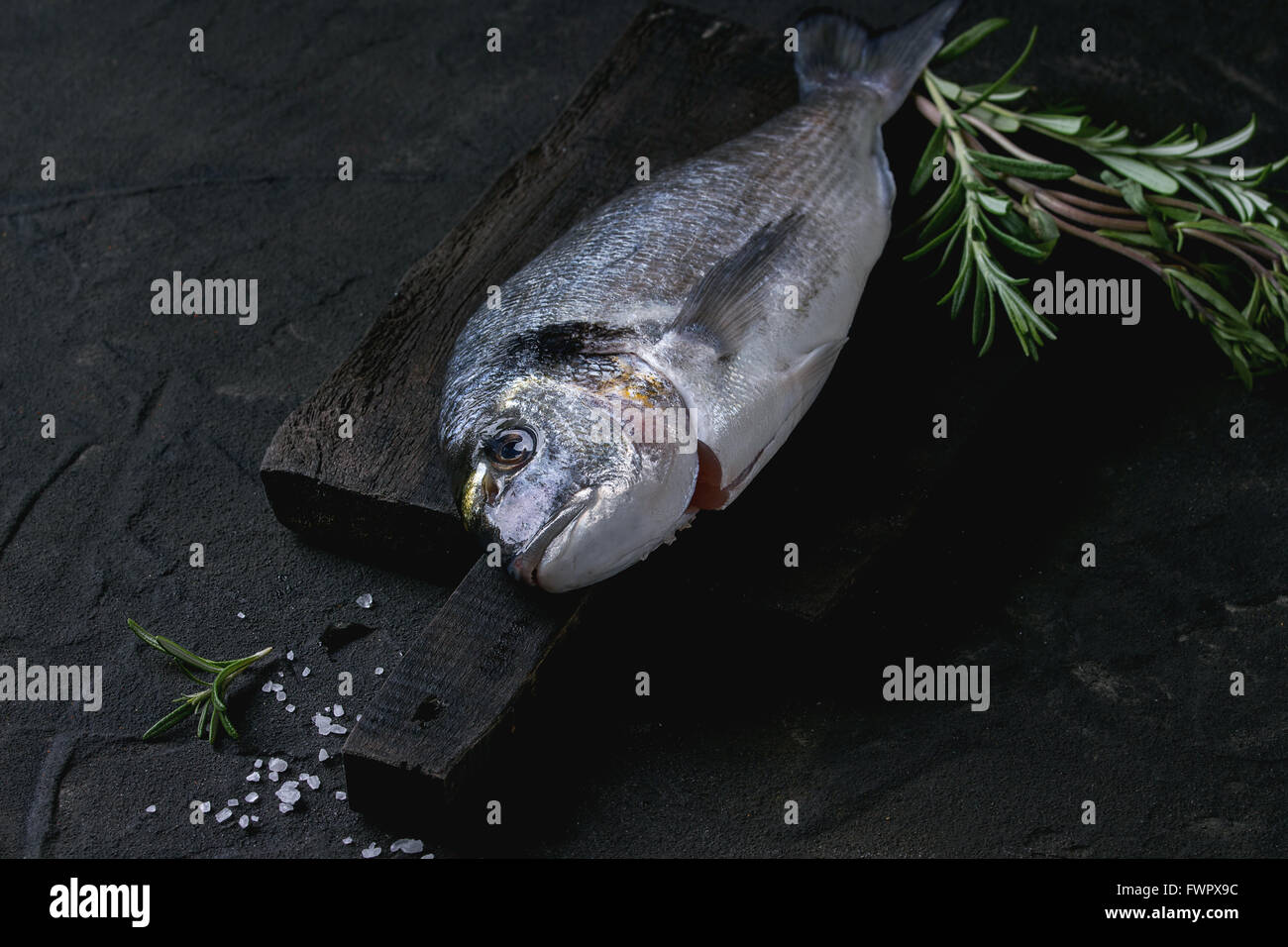 Raw bream fish with herbs Stock Photo - Alamy