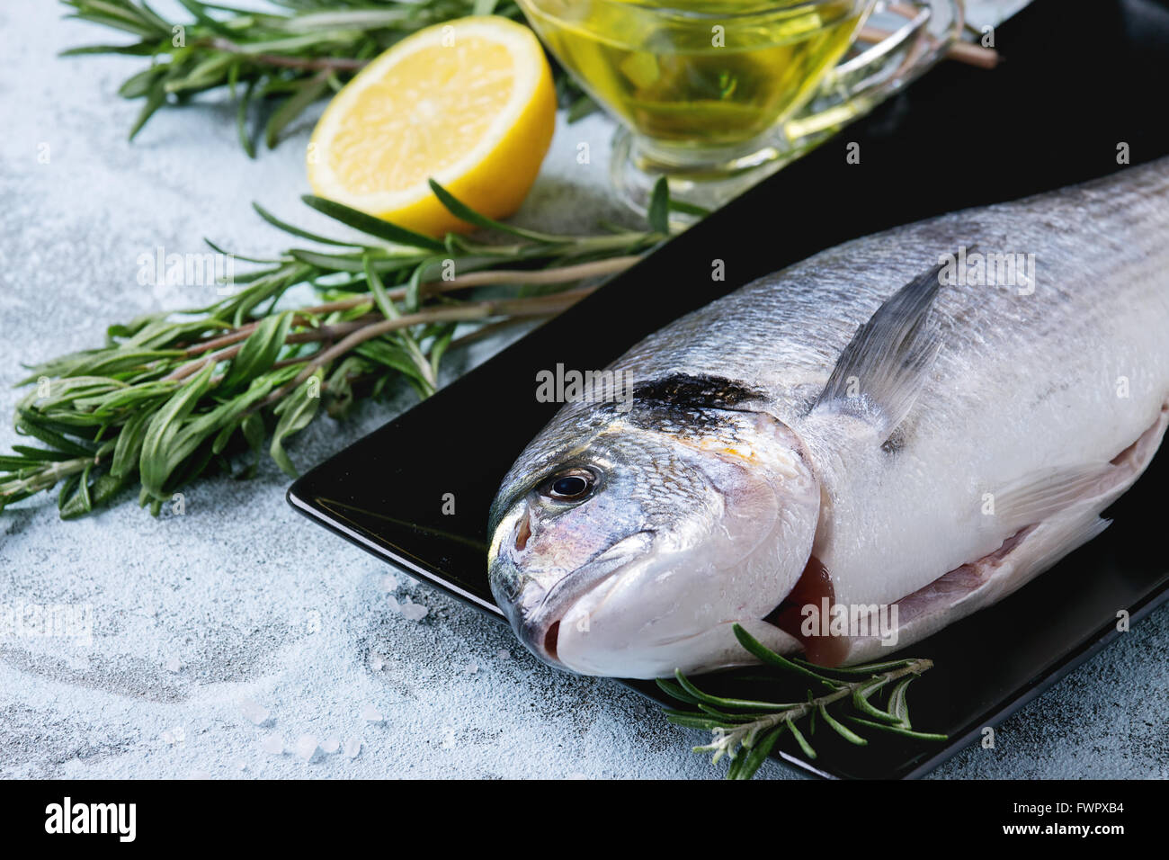 Raw bream fish with herbs Stock Photo - Alamy