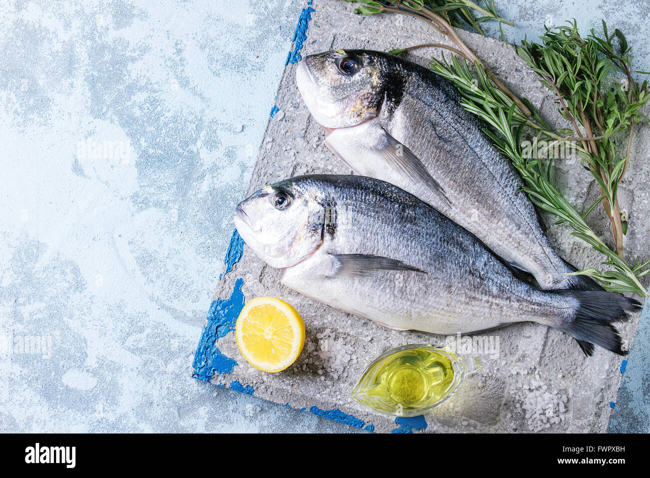 Raw bream fish with herbs Stock Photo - Alamy