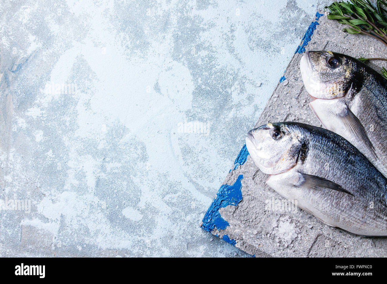 Raw bream fish with herbs Stock Photo - Alamy