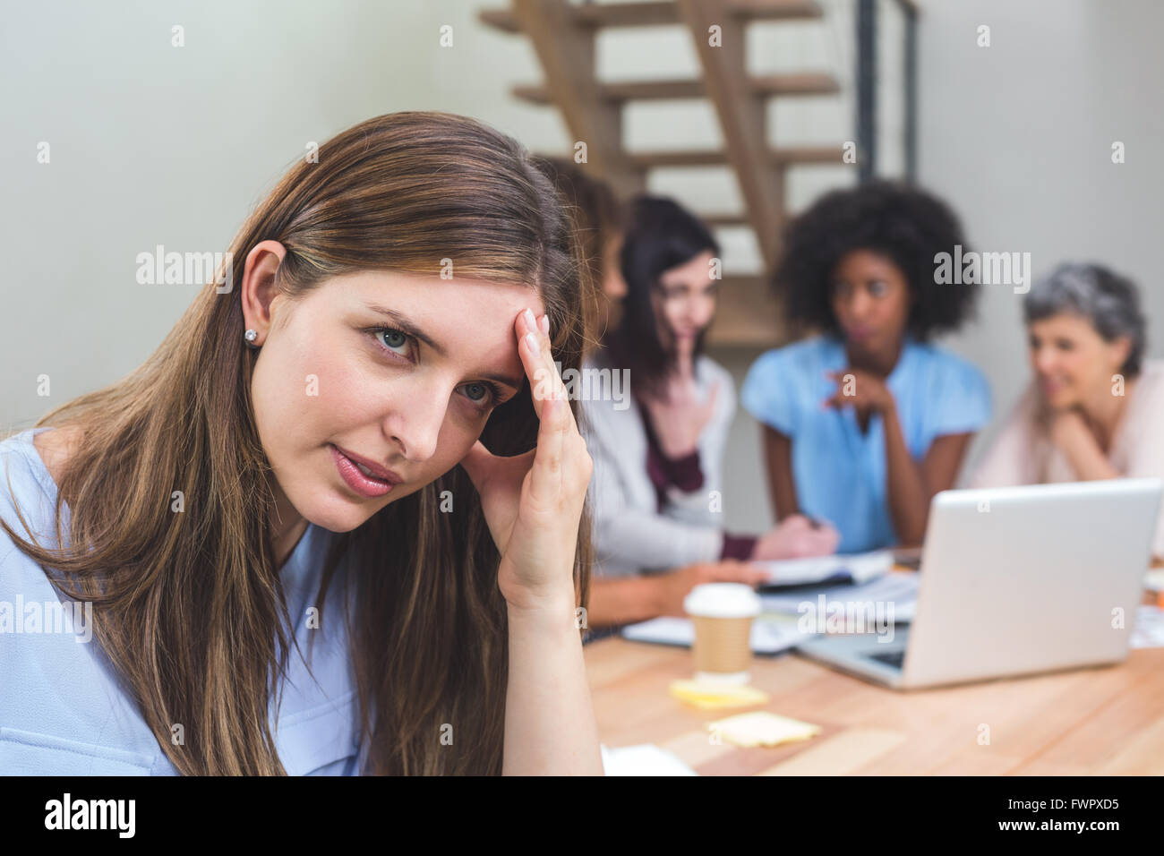 Tense businesswoman sitting in office Stock Photo - Alamy