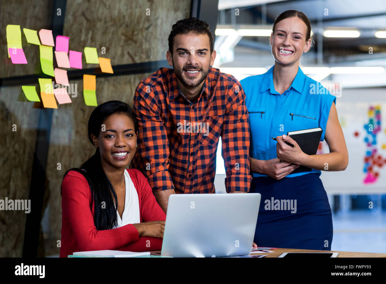 Colleagues smiling at camera Stock Photo - Alamy